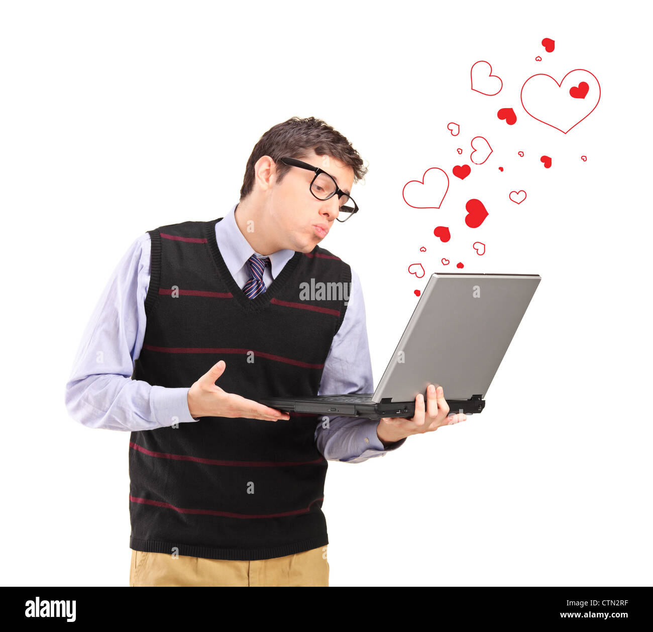 Young man giving a kiss on a laptop computer and red heart shapes ...