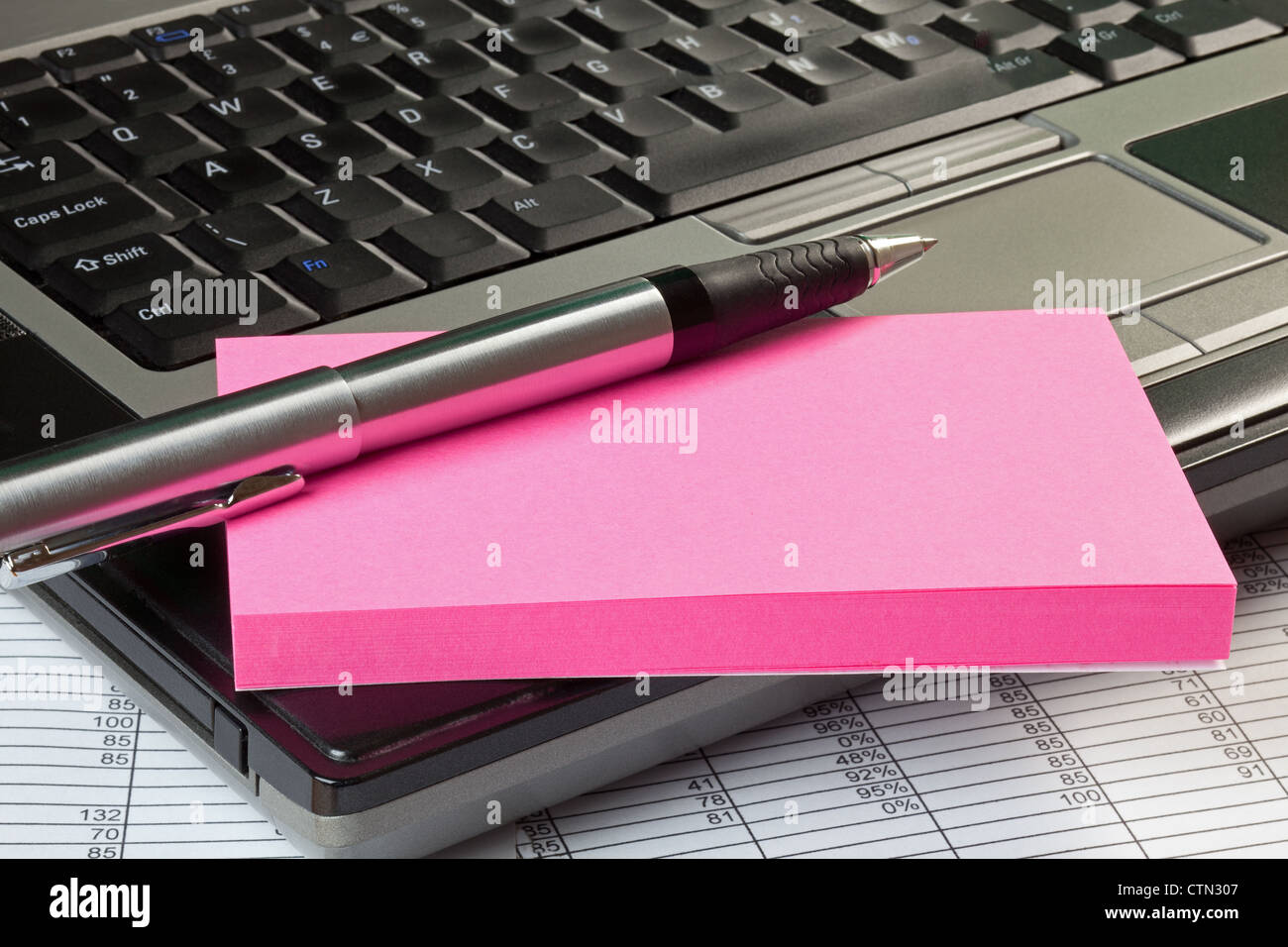 Laptop with spreadsheet,note pad and pen Stock Photo - Alamy