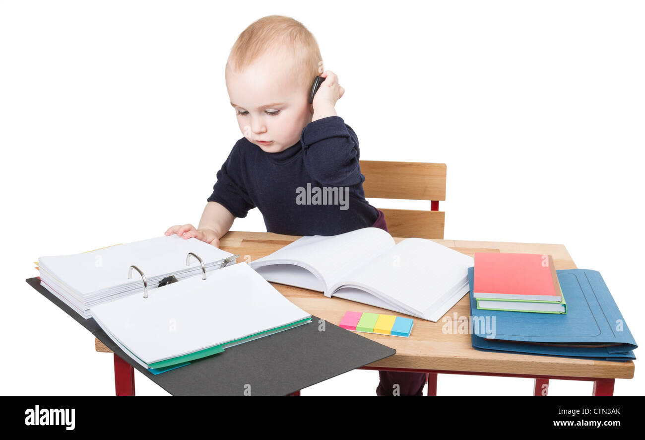 young child working at writing desk in light background Stock Photo - Alamy