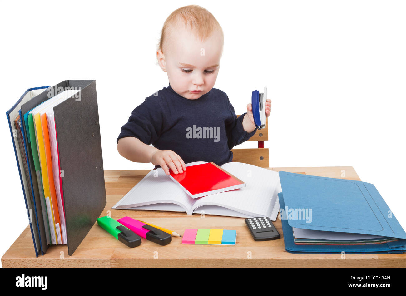 young child working at writing desk in light background Stock Photo - Alamy