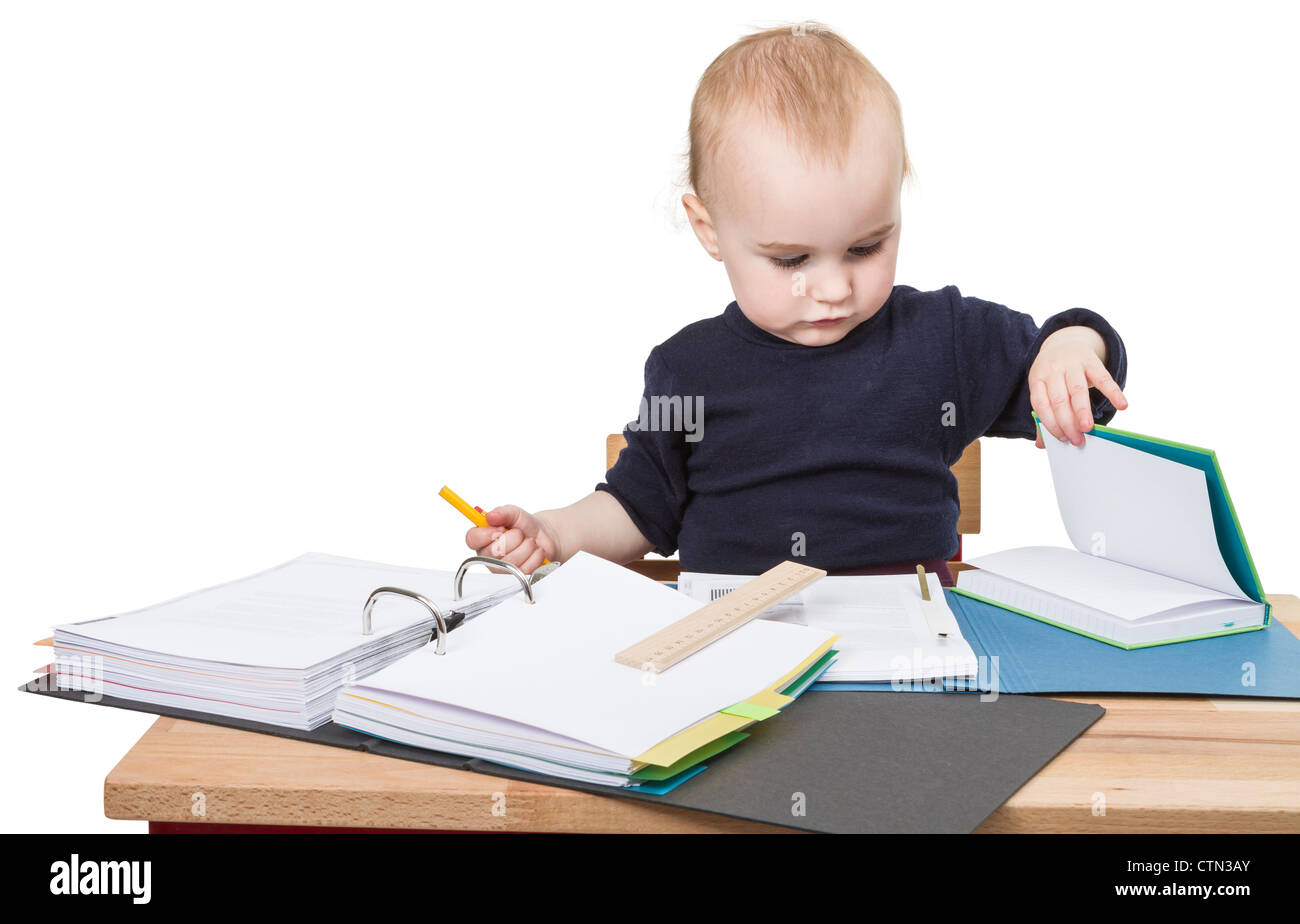young child working at writing desk in light background Stock Photo - Alamy