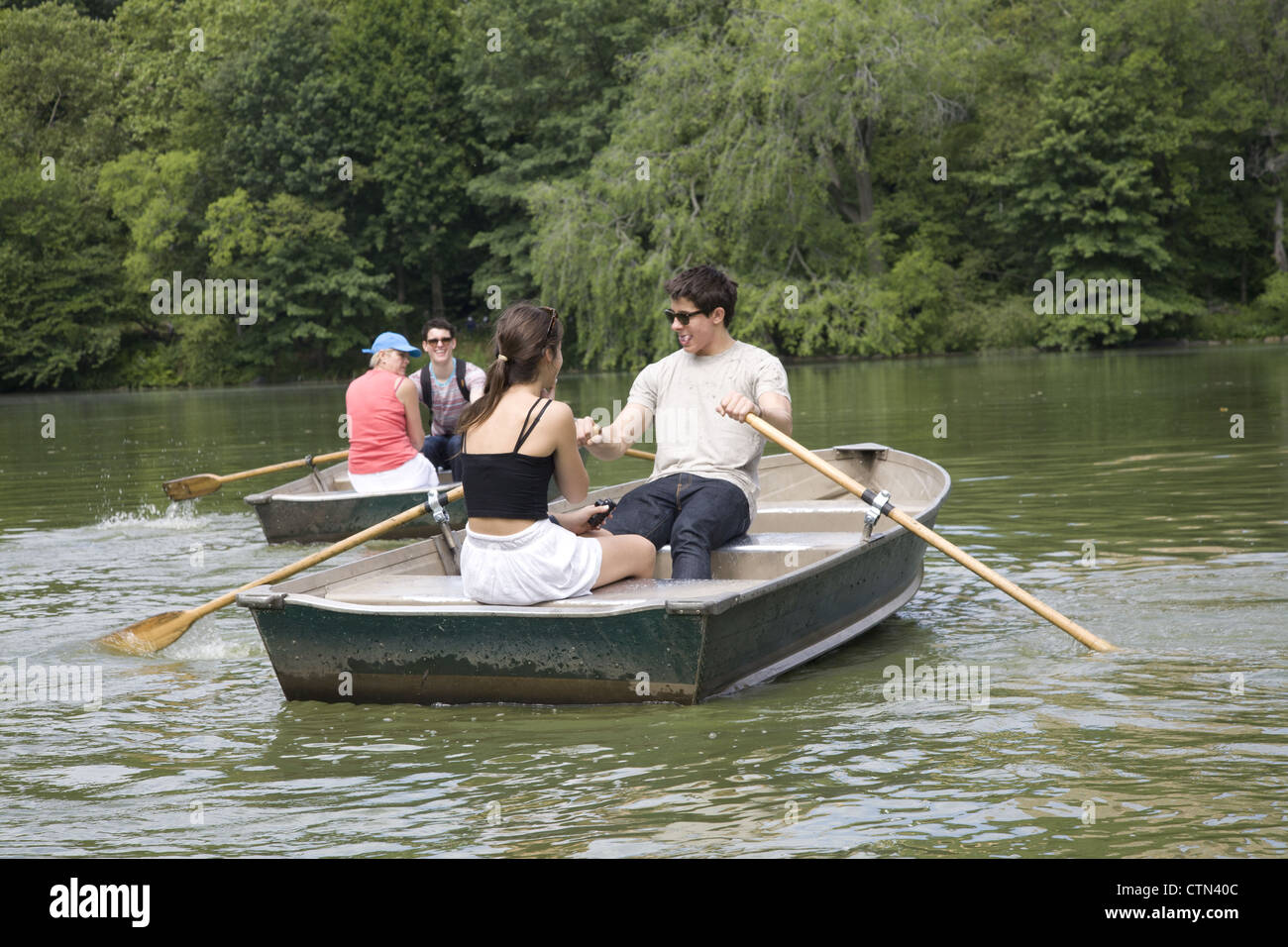 People enjoy rowing on the waterway in Central Park, New York City ...