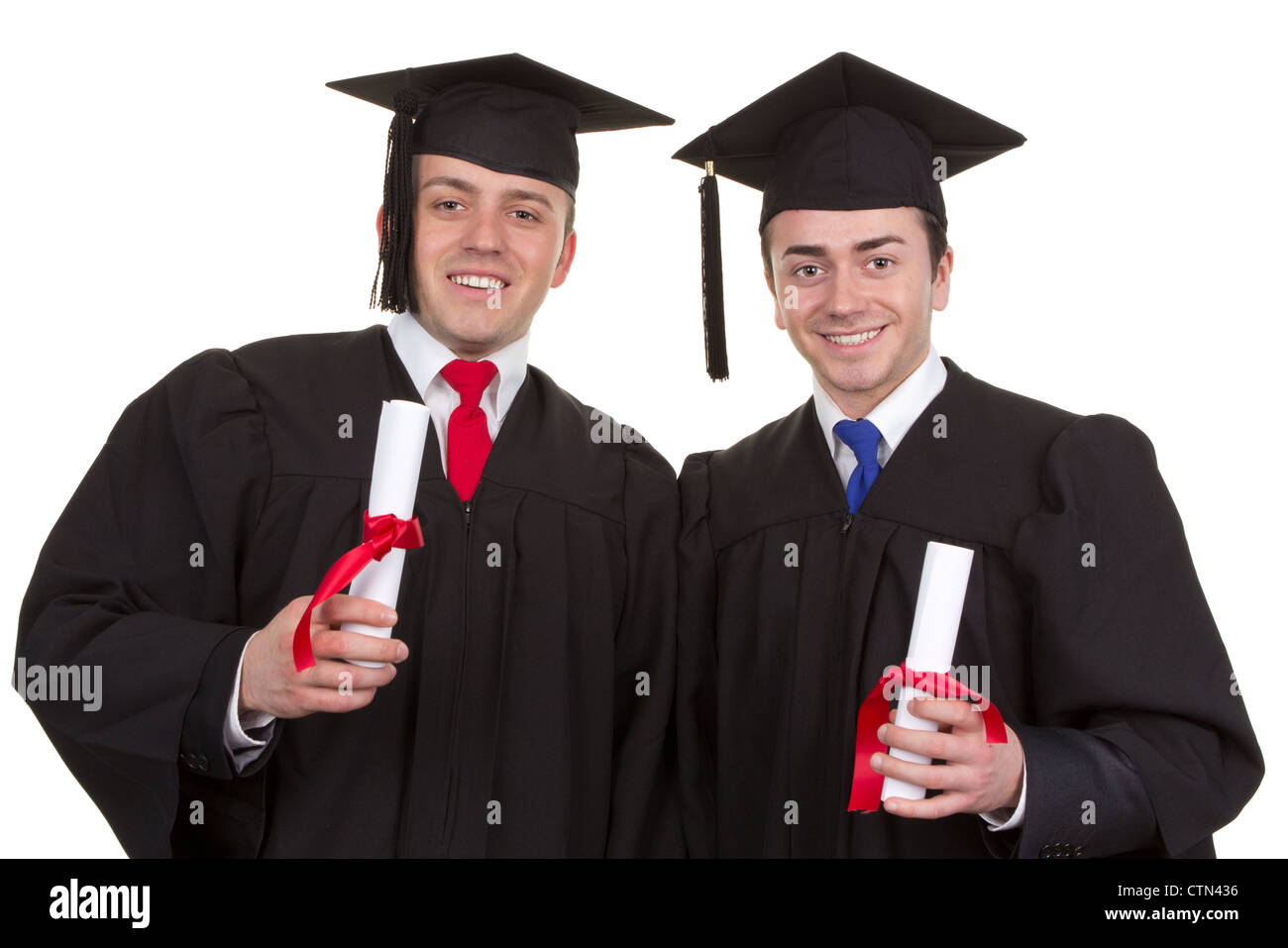 Two glad graduates holding their new qualifications, isolated on white ...