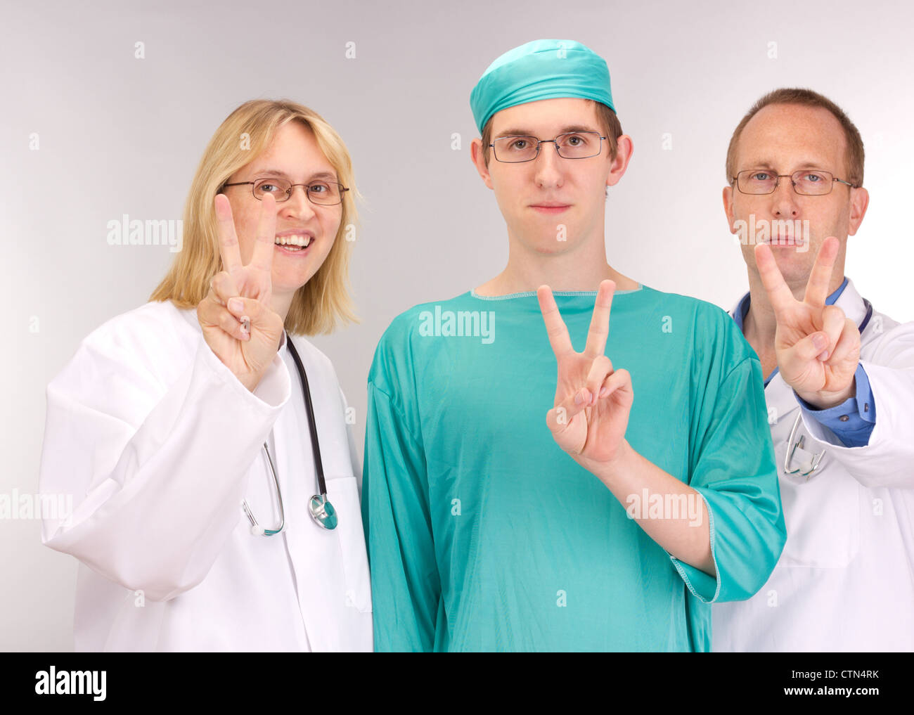 Team consisting of three medical doctors showing victory signs Stock ...