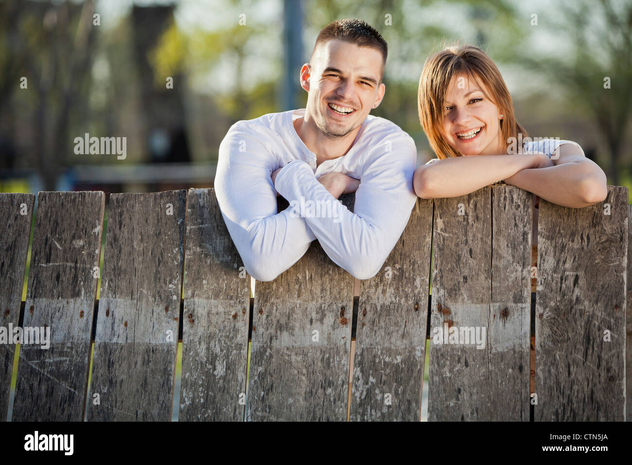 Young couple by the fence Stock Photo - Alamy