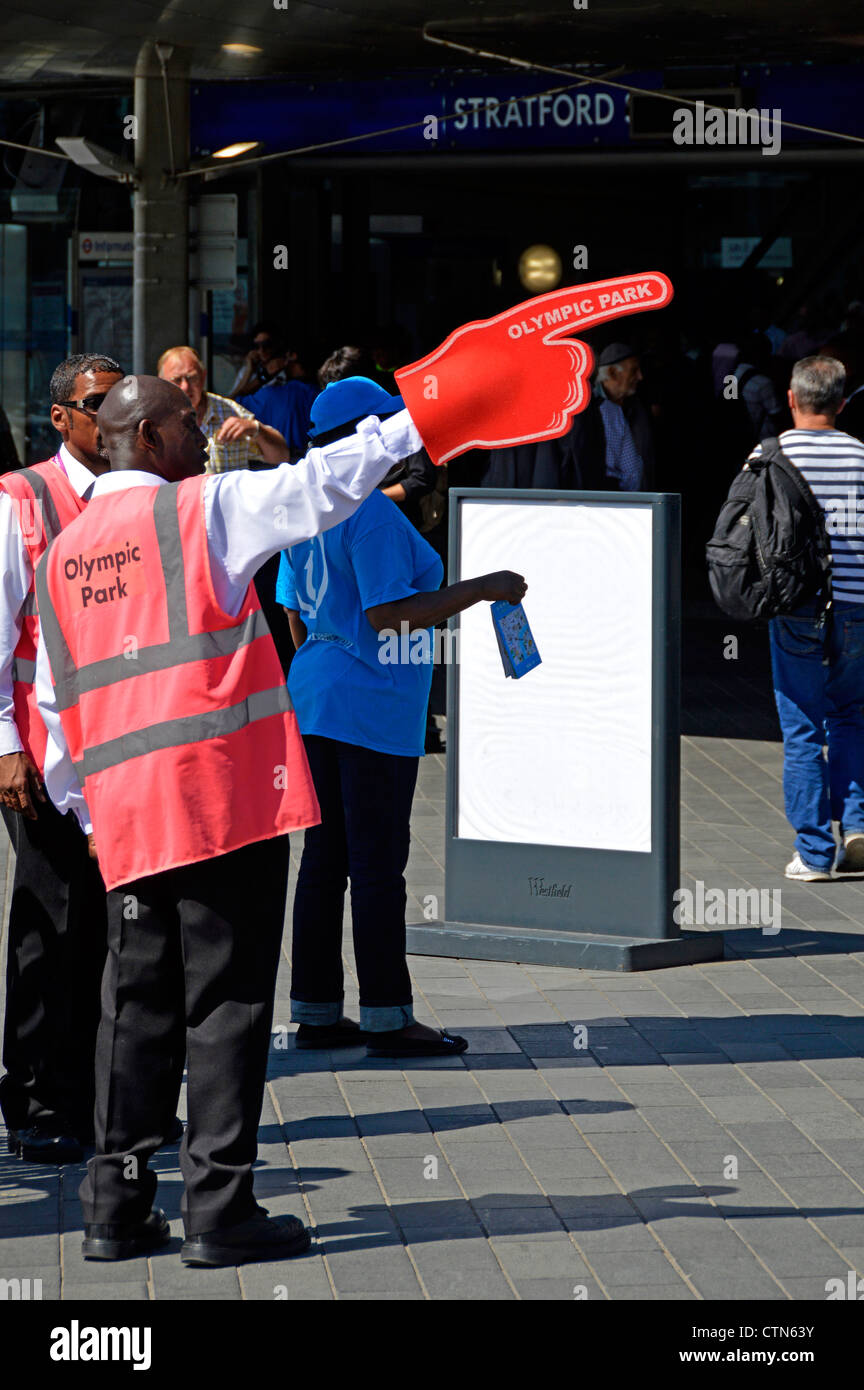 Olympic Park helpers outside Stratford railway station giving finger ...