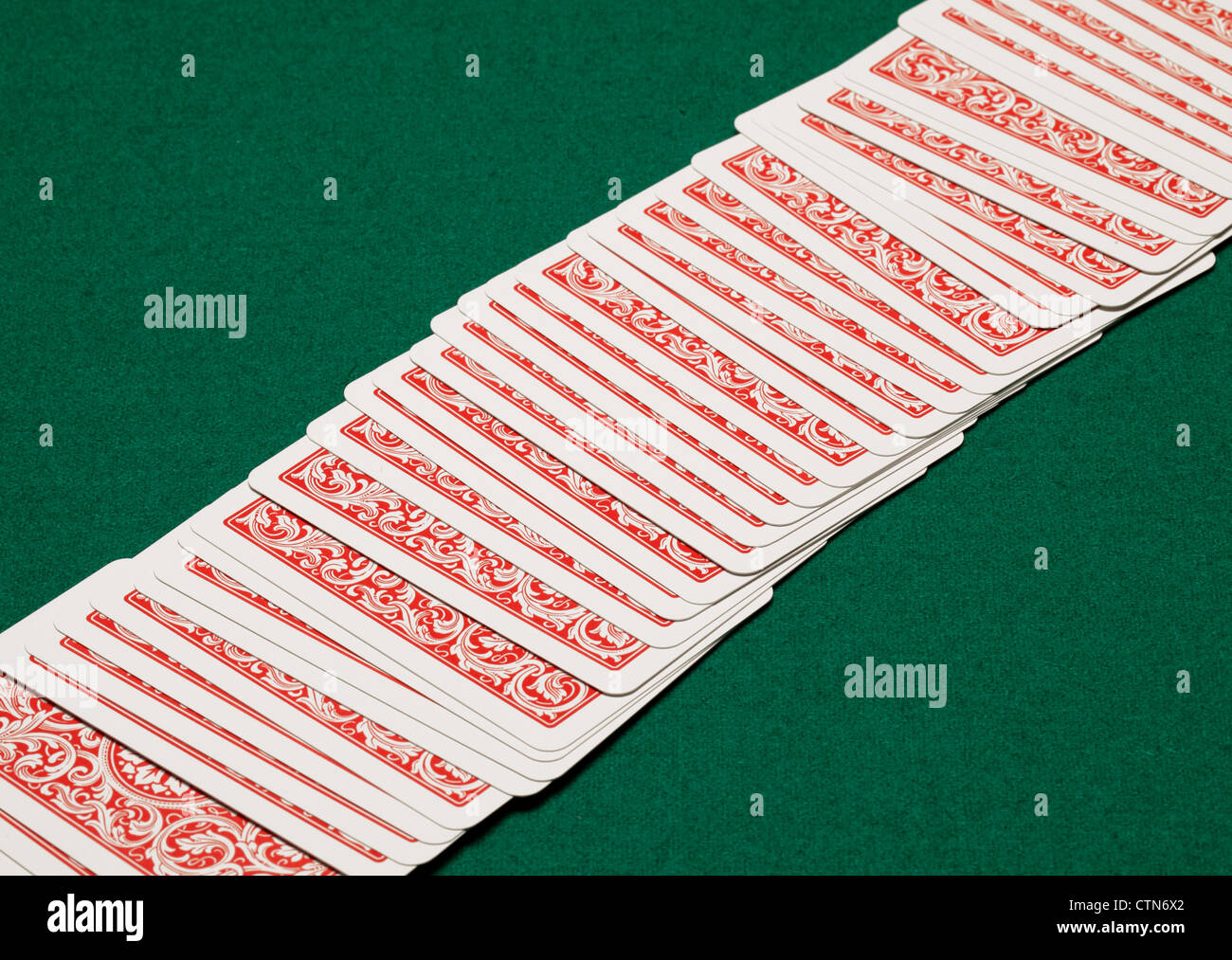 Playing cards on a green table Stock Photo - Alamy