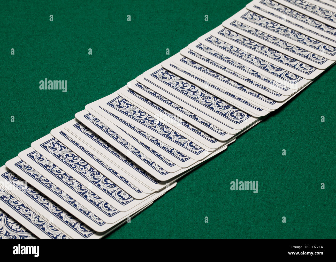 Playing cards on a green table Stock Photo - Alamy