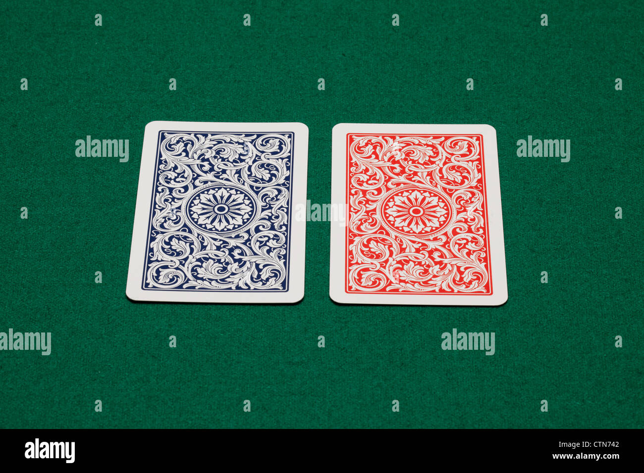 Playing cards on a green table Stock Photo - Alamy