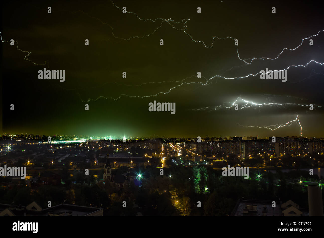 Lightning over the city at night with lights Stock Photo - Alamy