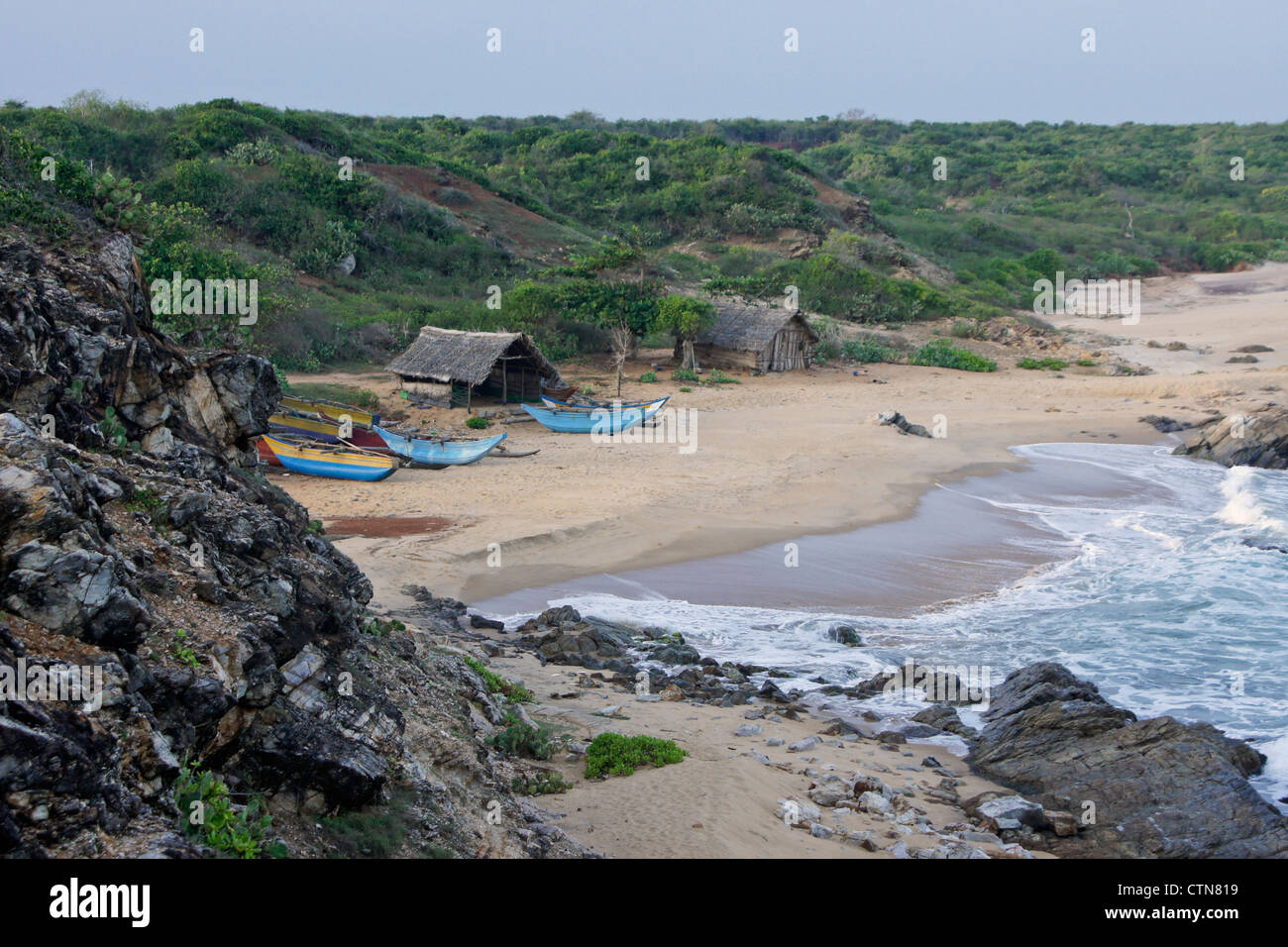 Fishing shacks and outrigger boats on beach, Bundala National Park, Sri ...
