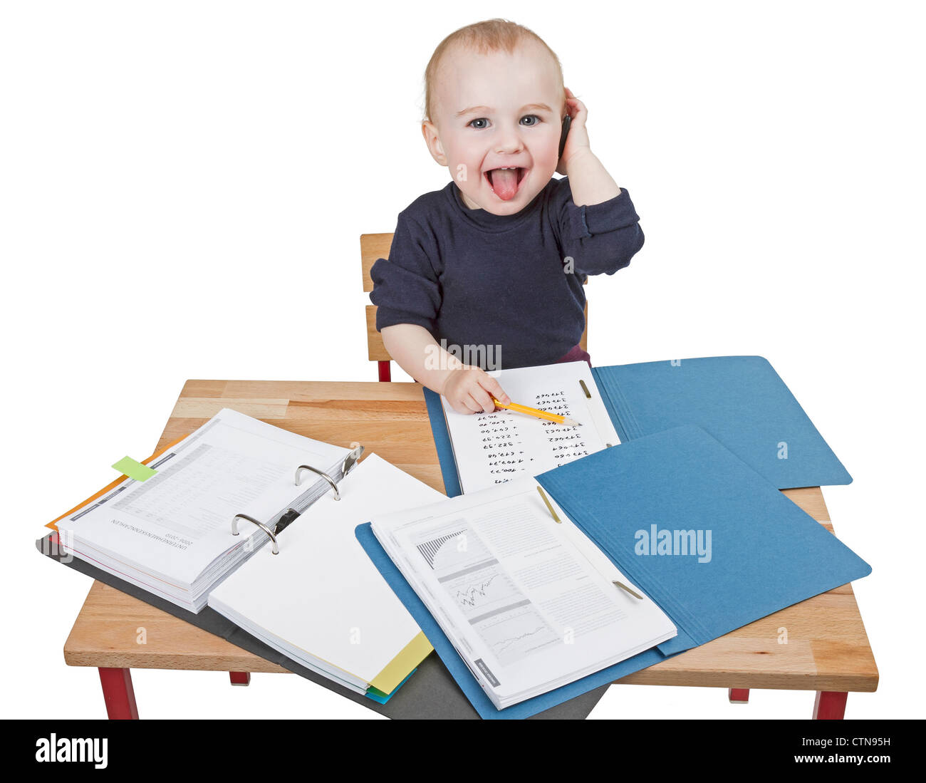 young child working at writing desk in light background Stock Photo - Alamy