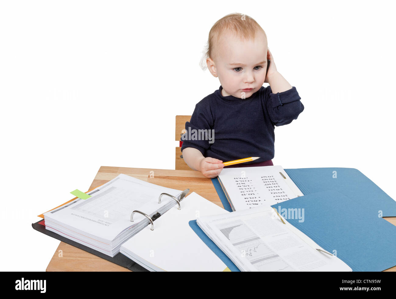 young child working at writing desk in light background Stock Photo - Alamy