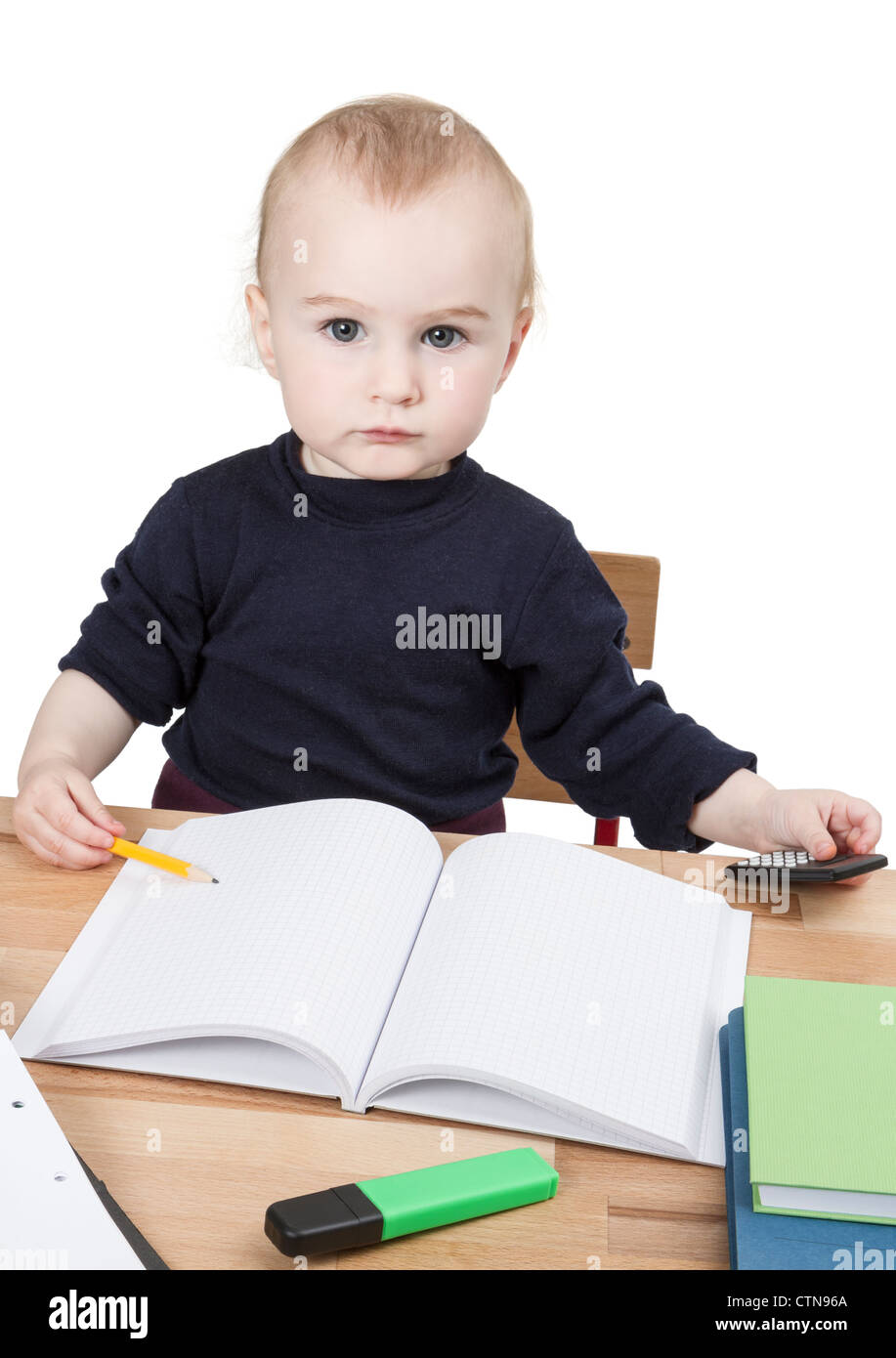 young child working at writing desk in light background Stock Photo - Alamy