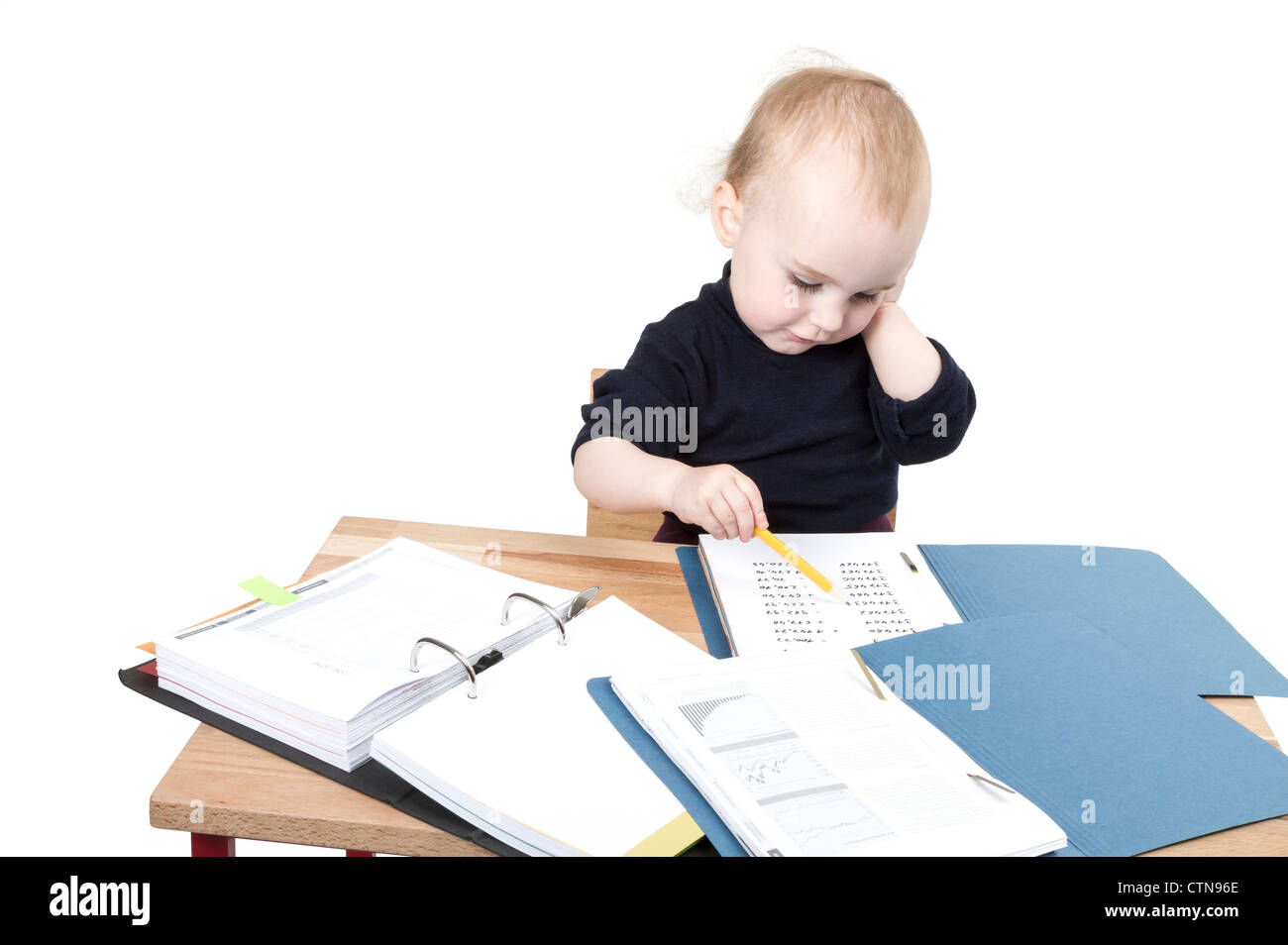 young child working at writing desk in light background Stock Photo - Alamy