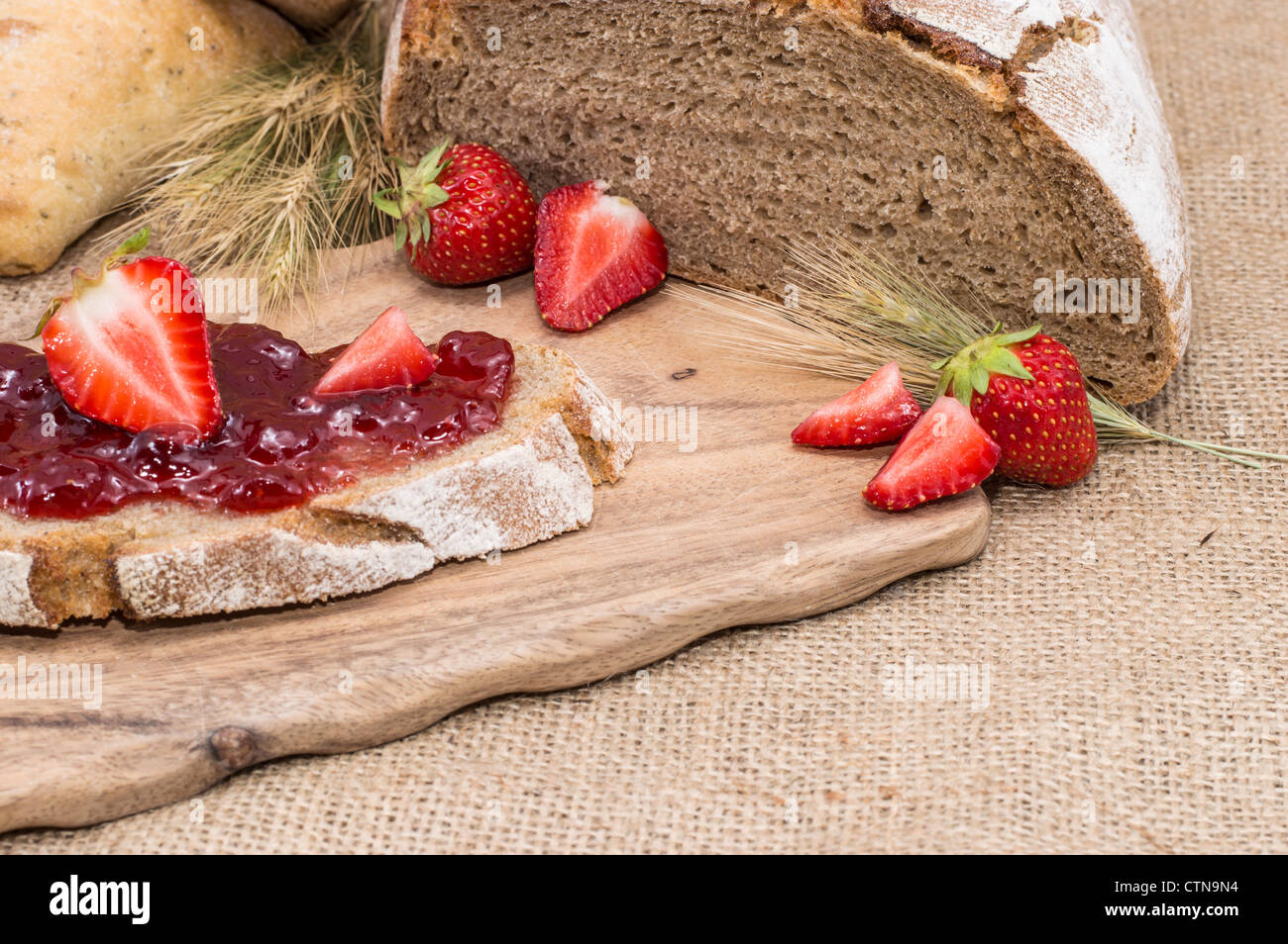 Rustic Bread with fresh Strawberry Jam and fruits Stock Photo - Alamy
