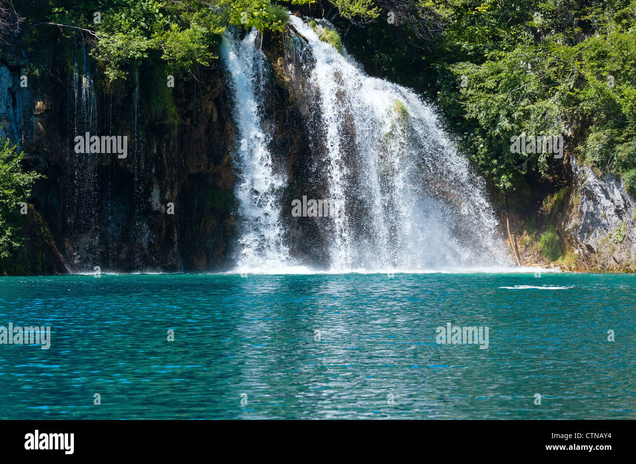 Beautiful waterfall and sea-green limpid lake in Plitvice Lakes ...