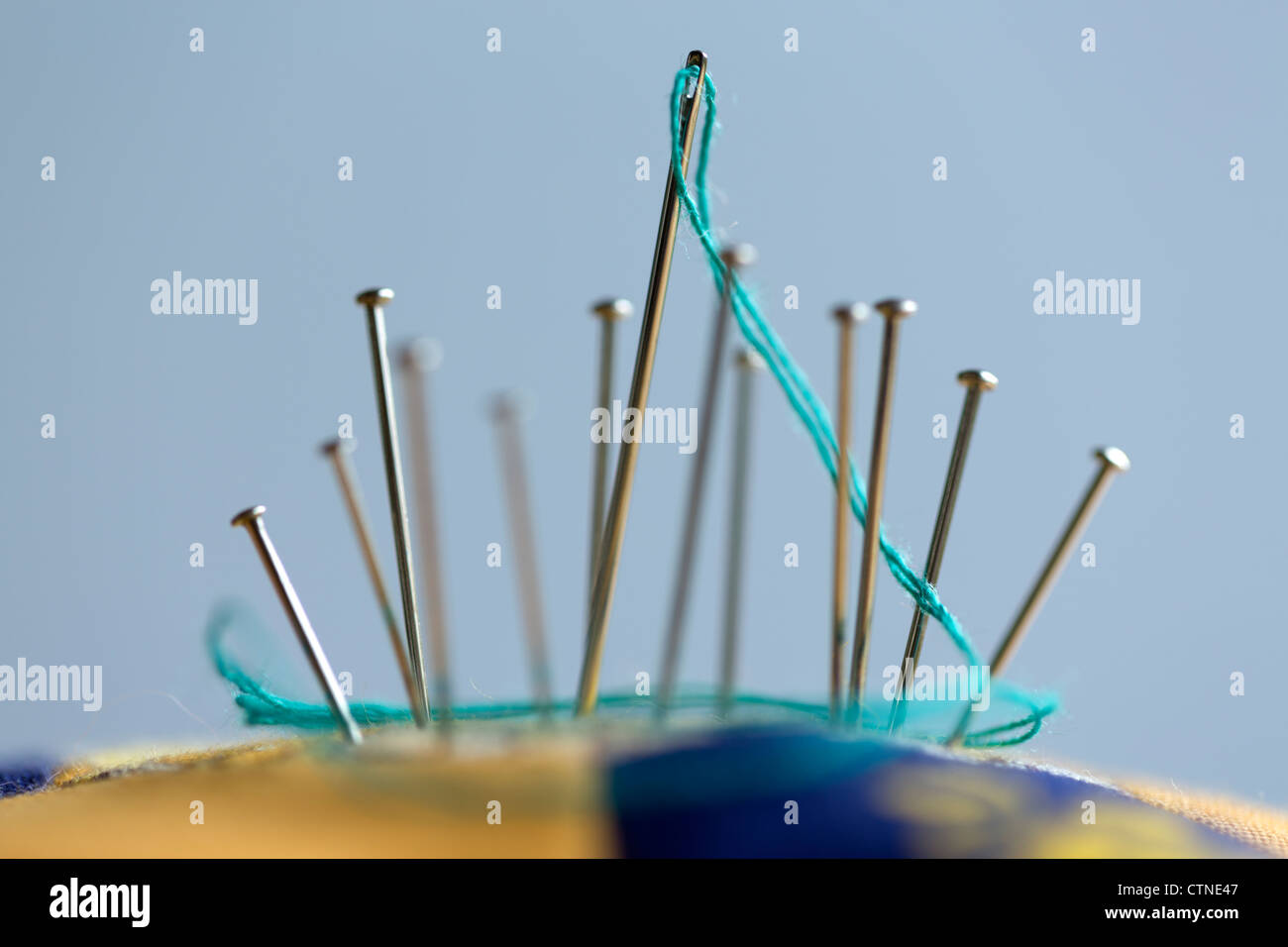 Pins and needle in pincushion Stock Photo - Alamy