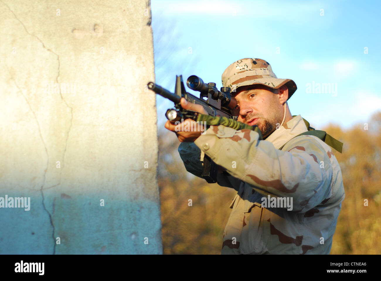 Soldier in camouflage aiming with his rifle outdoor Stock Photo - Alamy