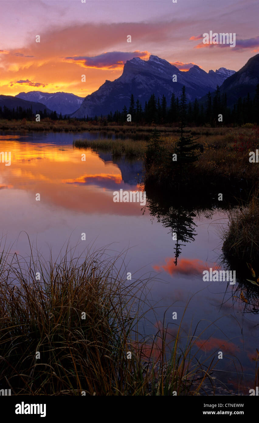 The sky is lit up as the sun rises in the First Vermillion Lake, on ...