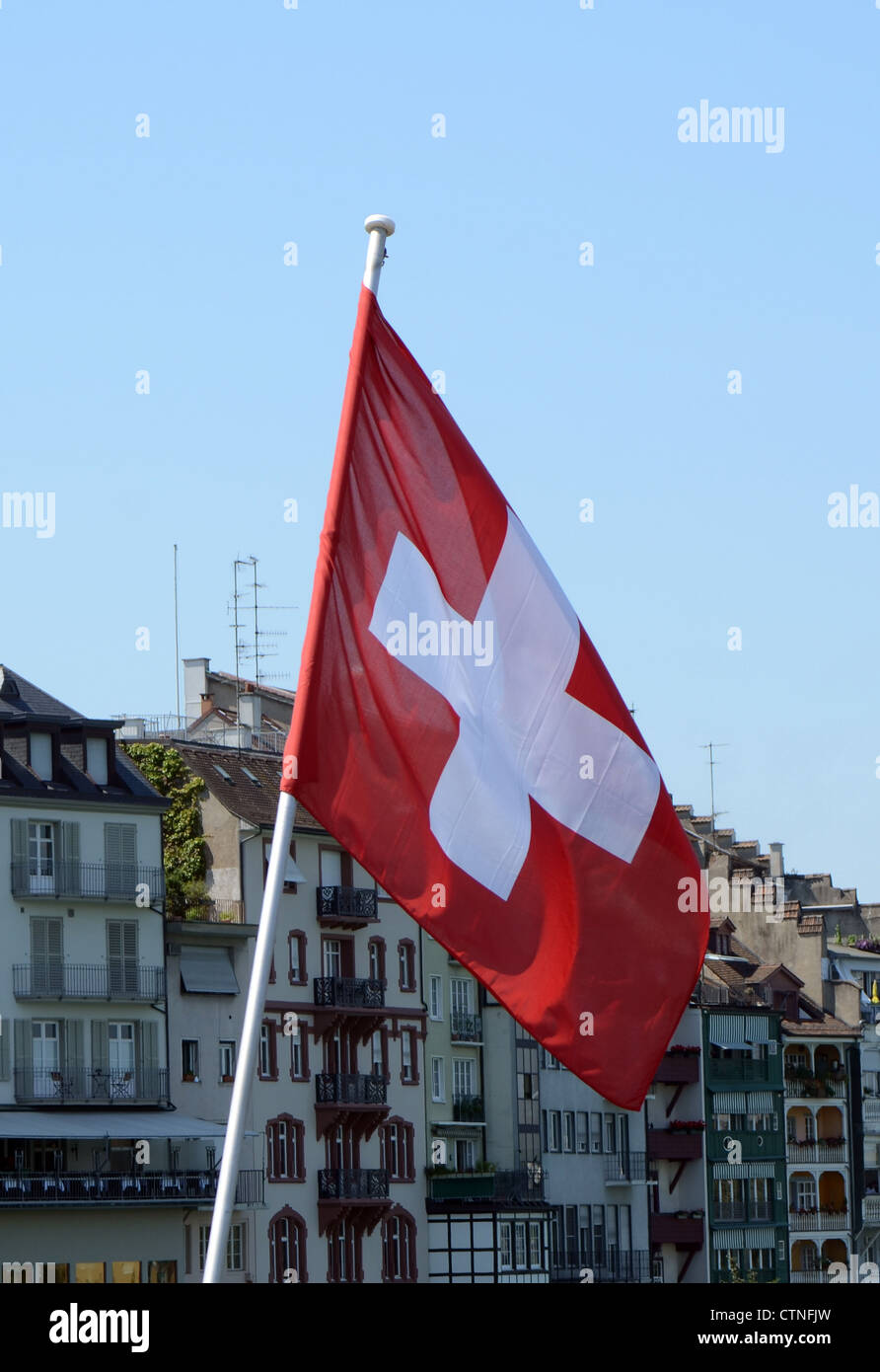 Photo of the Swiss flag with old houses of Basel in the background ...