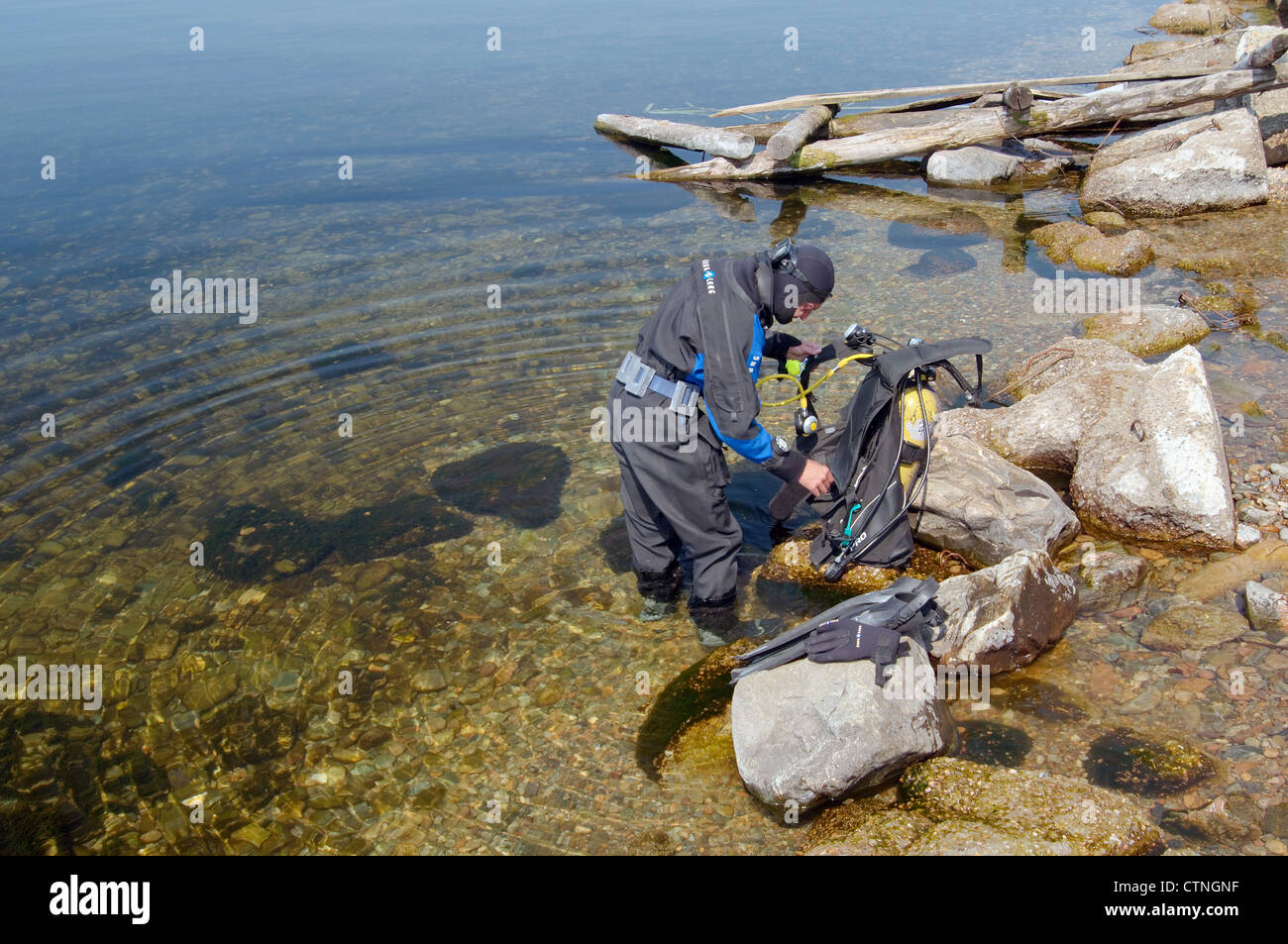 diver prepares to diving in Baikal lake, Siberia, Russian Federation ...