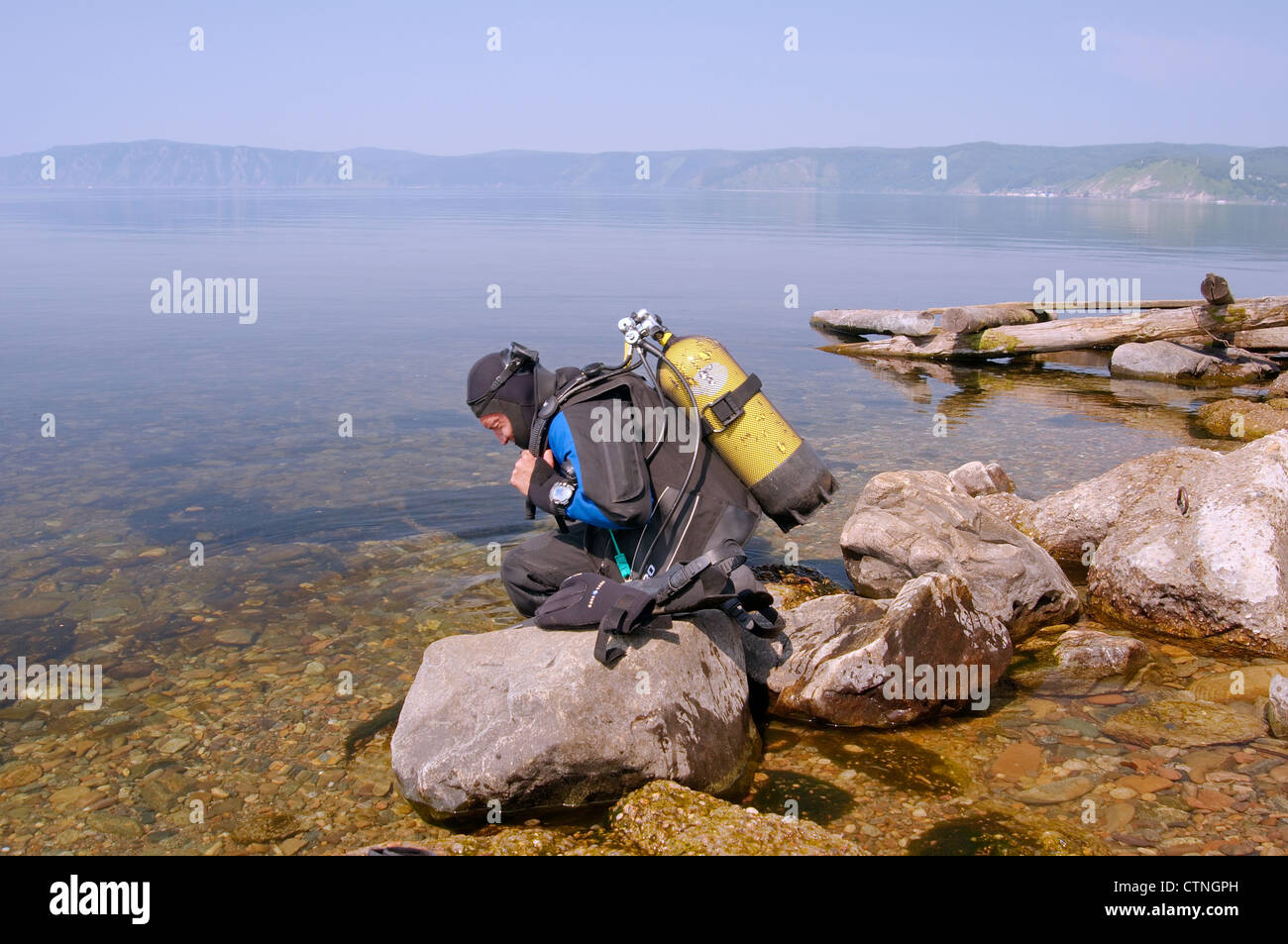 diver prepares to diving in Baikal lake, Siberia, Russian Federation ...