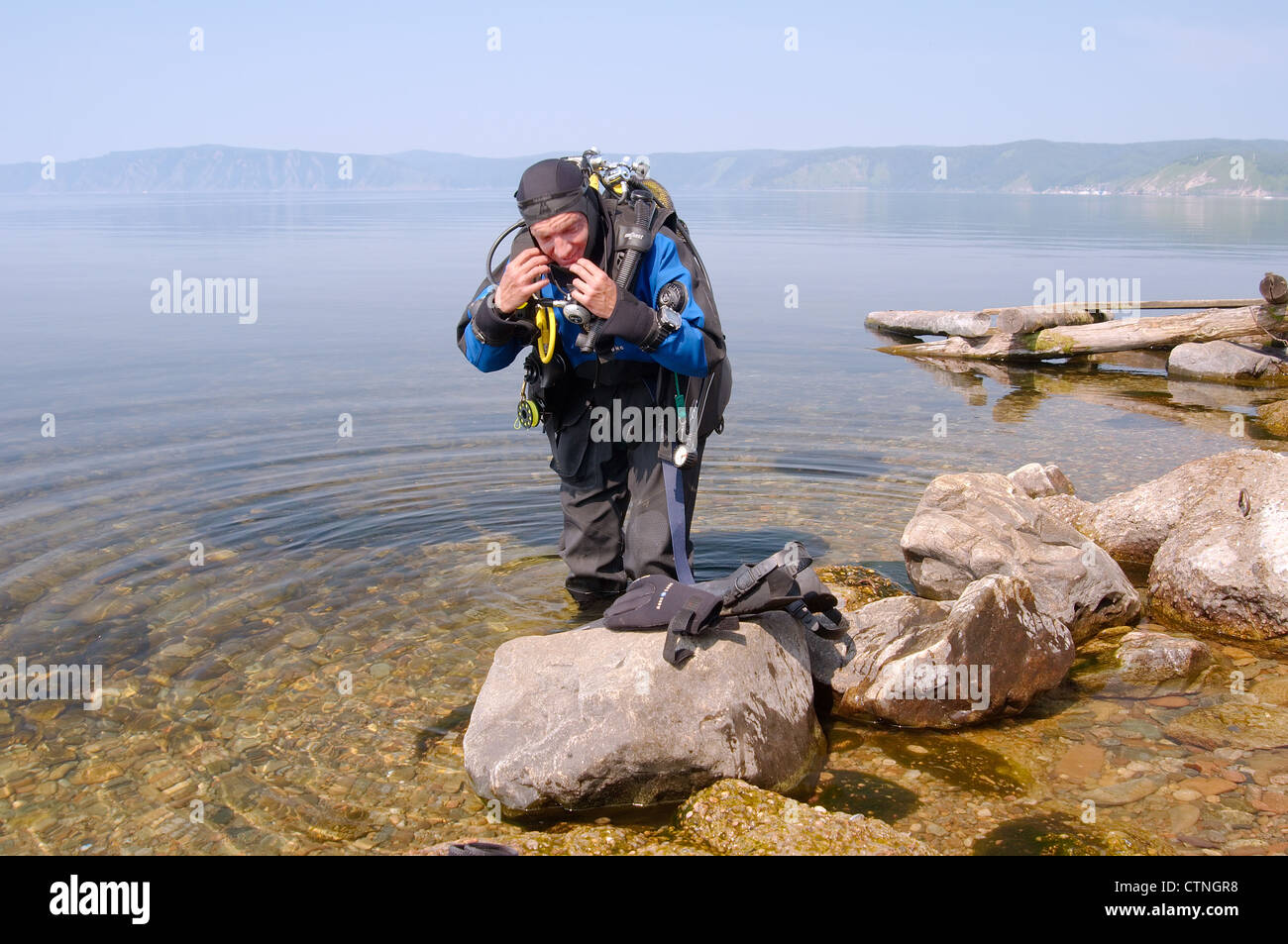 diver prepares to diving in Baikal lake, Siberia, Russian Federation ...