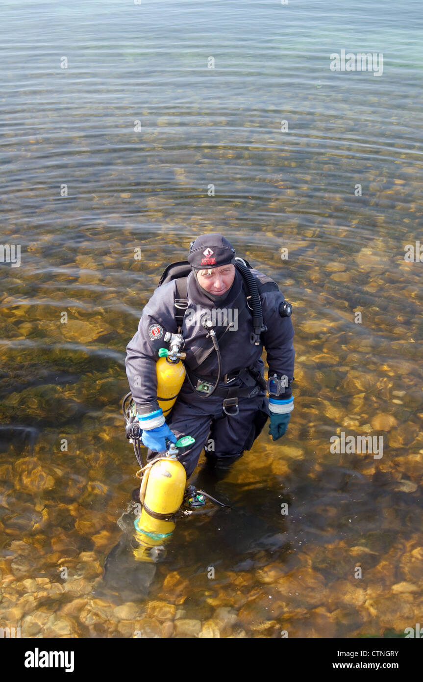 diver prepares to diving in Baikal lake, Siberia, Russian Federation ...