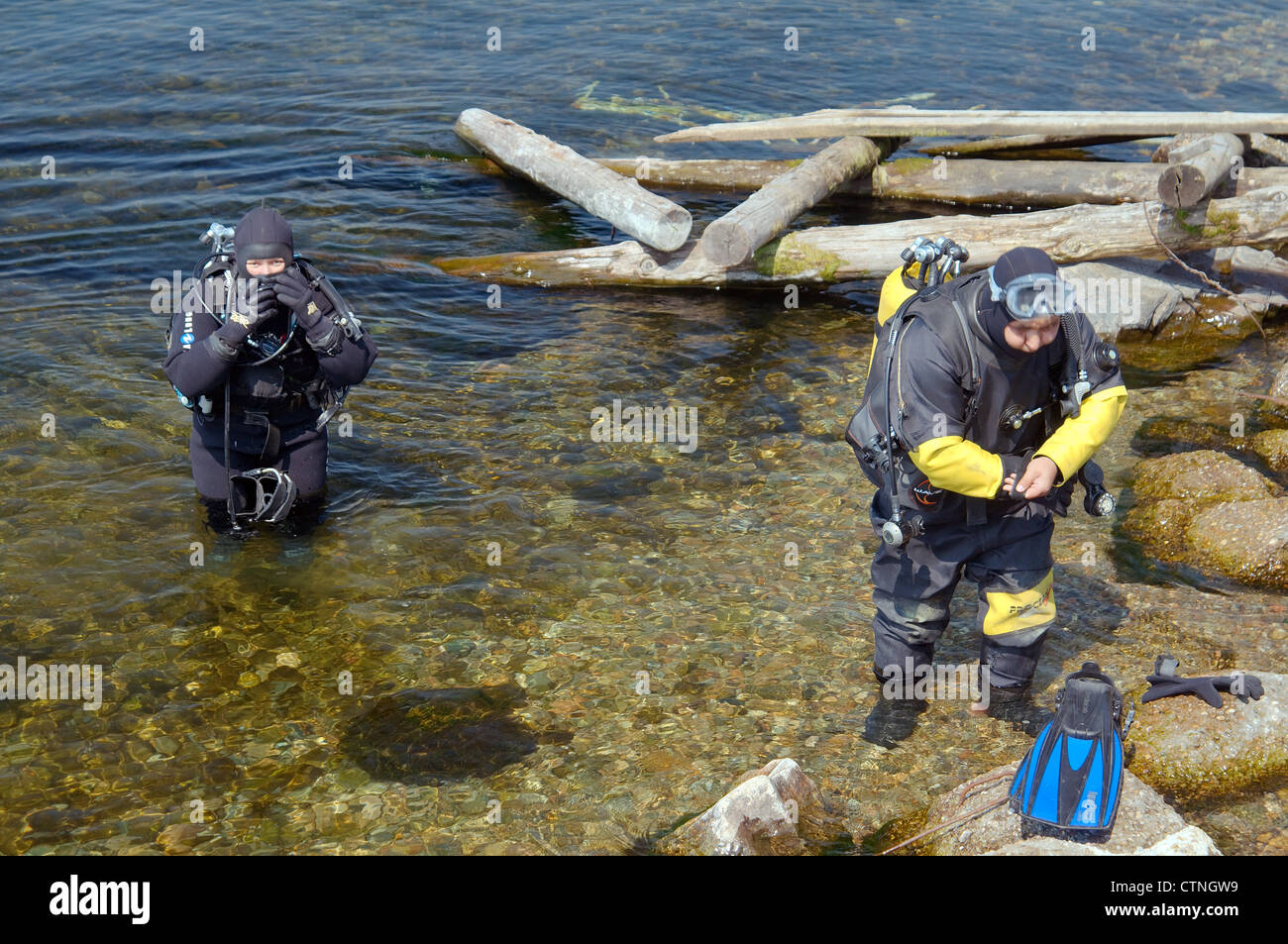 diver prepares to diving in Baikal lake, Siberia, Russian Federation ...
