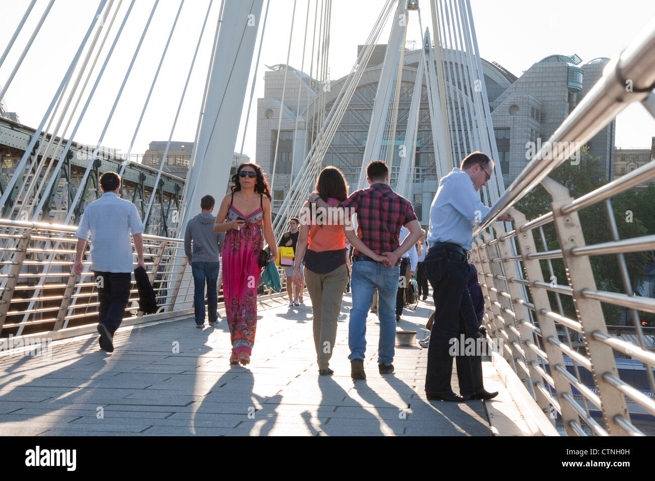 Couple Embracing with Elegant Women on Golden Jubilee Bridge; London ...