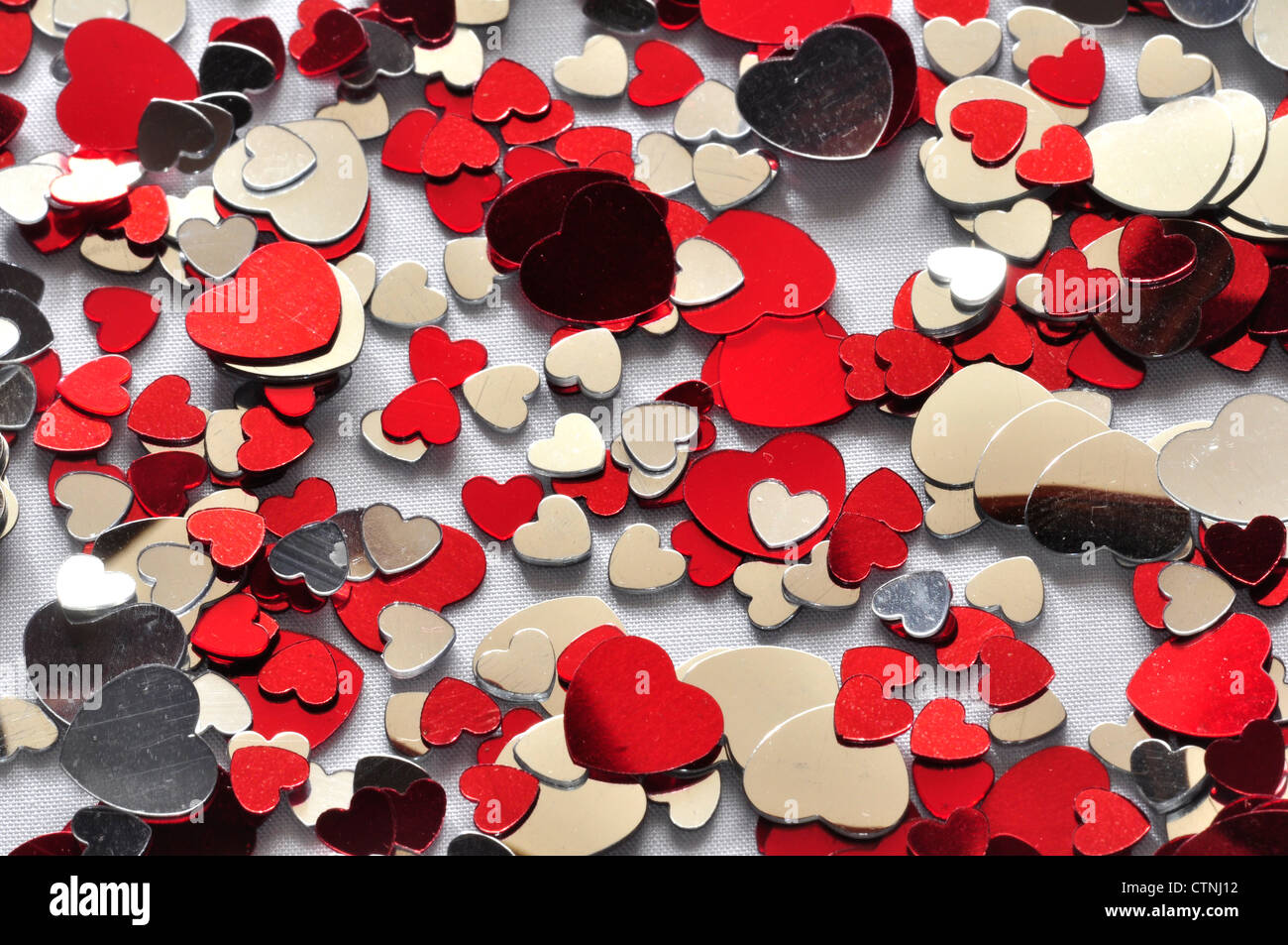 A scattering of red and silver hearts, both big and small Stock Photo ...
