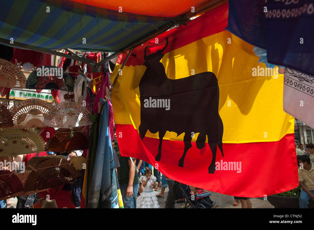 Spainsh flag and souvenir stall in street market at carnival, Spain ...