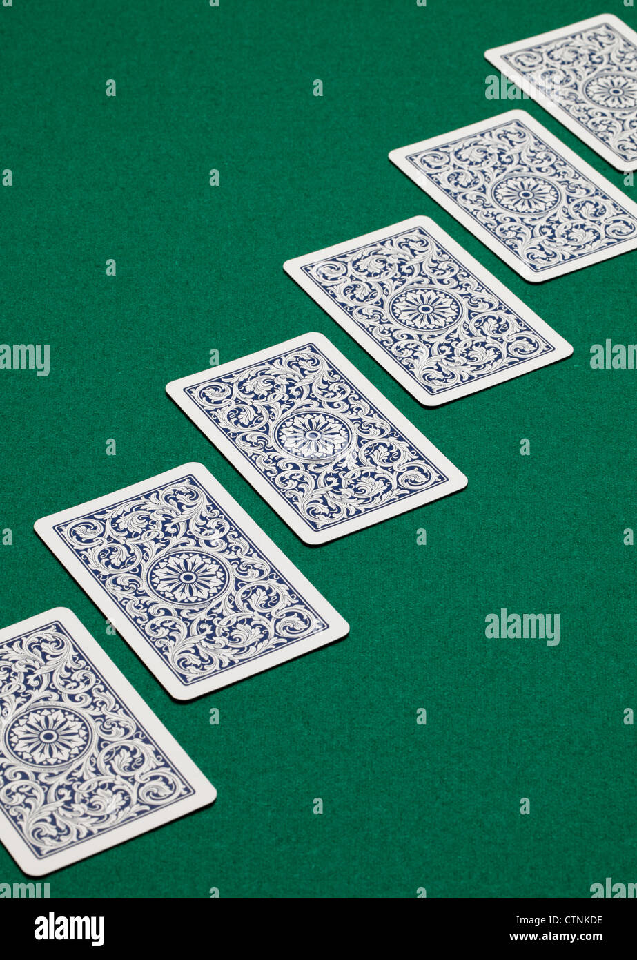 Playing cards on a green table Stock Photo - Alamy