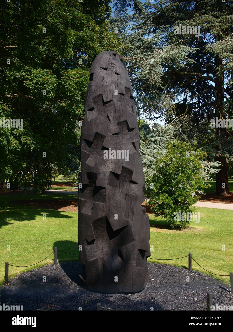 Wooden pillar 2-3 m high with crosses cut into the blackened surface ...