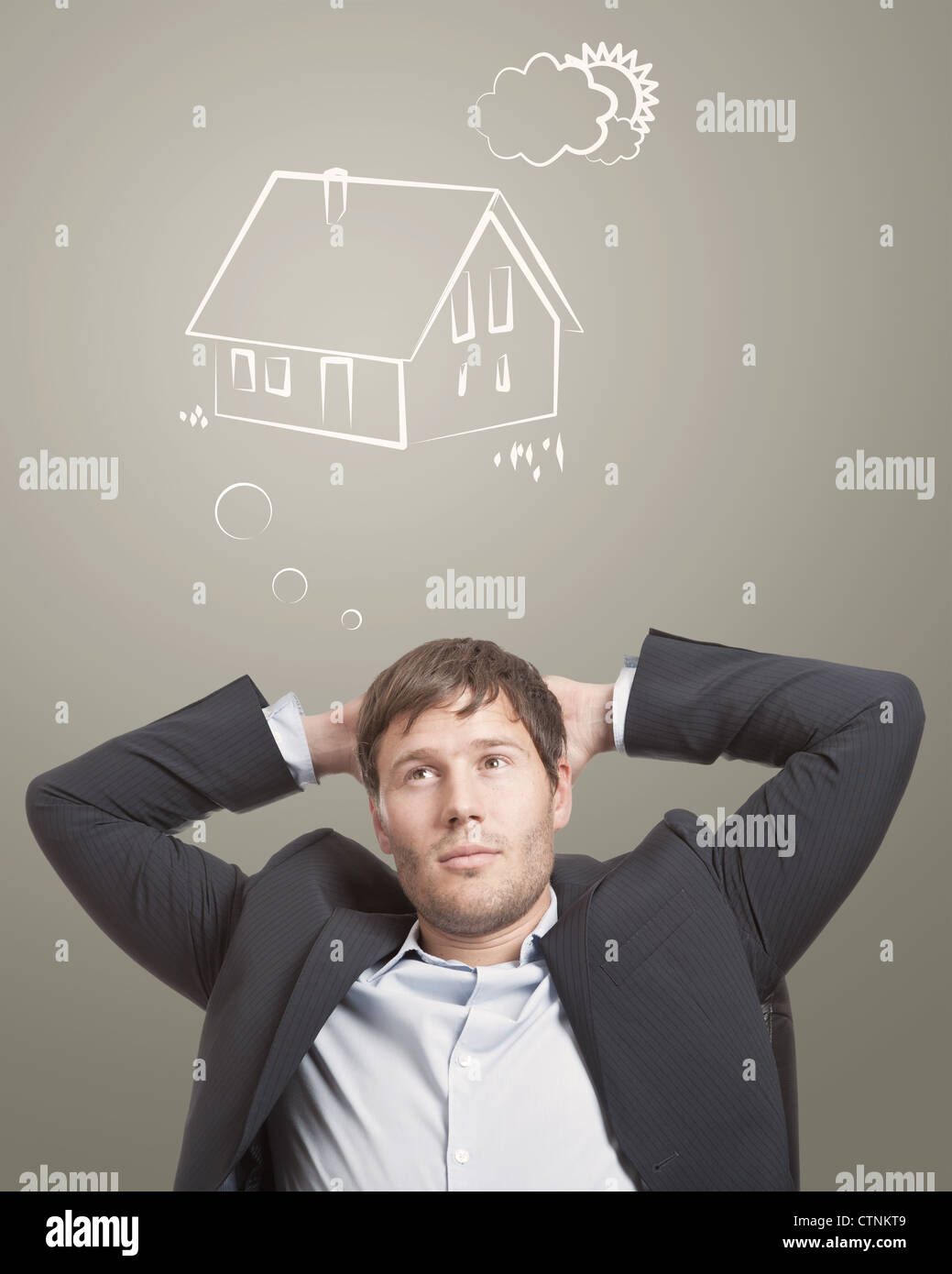 Young man thinking about his dream house Stock Photo - Alamy