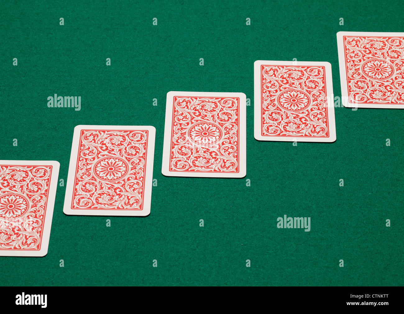 Playing cards on a green table Stock Photo - Alamy