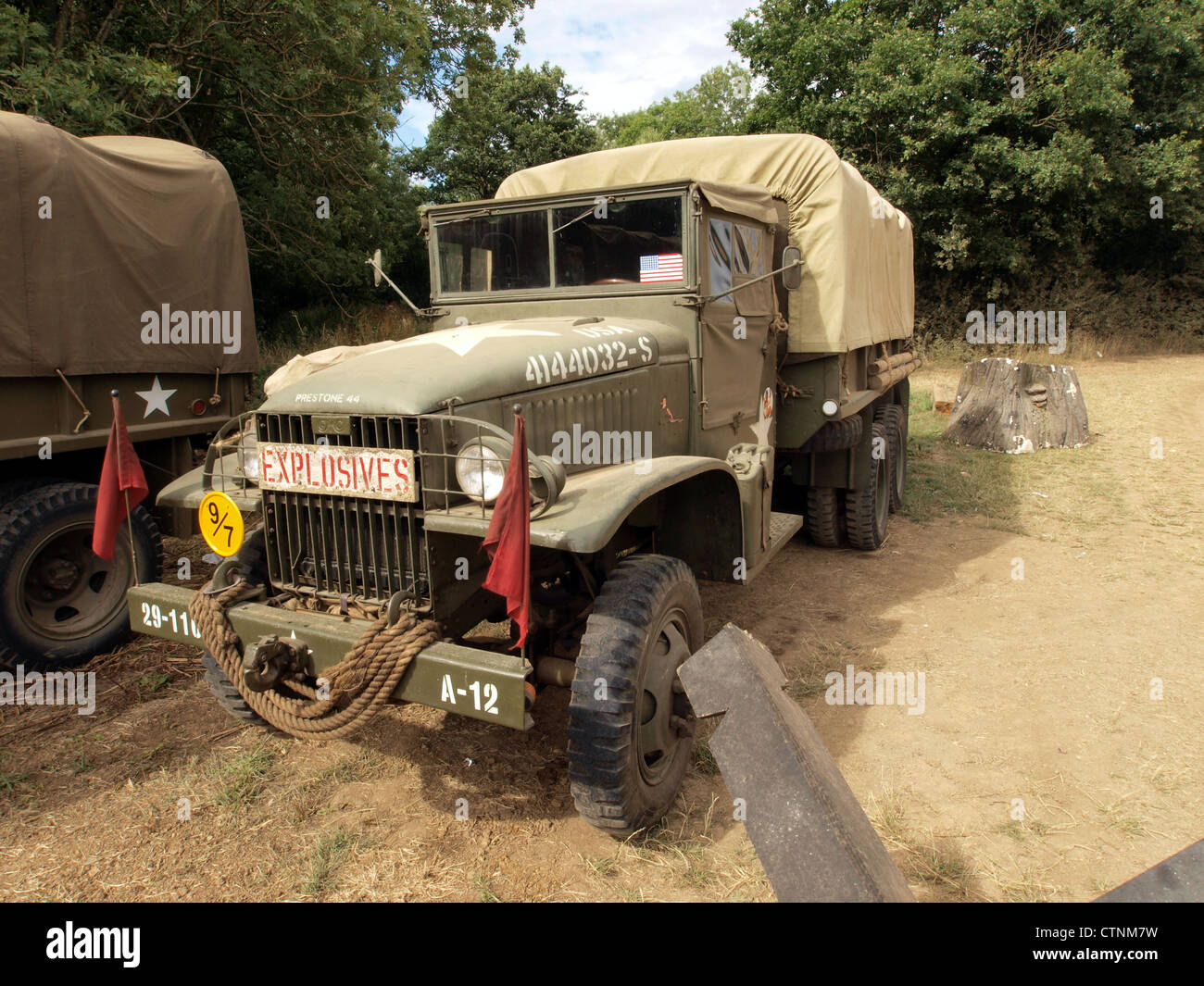 A GMC military truck with a hood, built for use during wartime, is ...