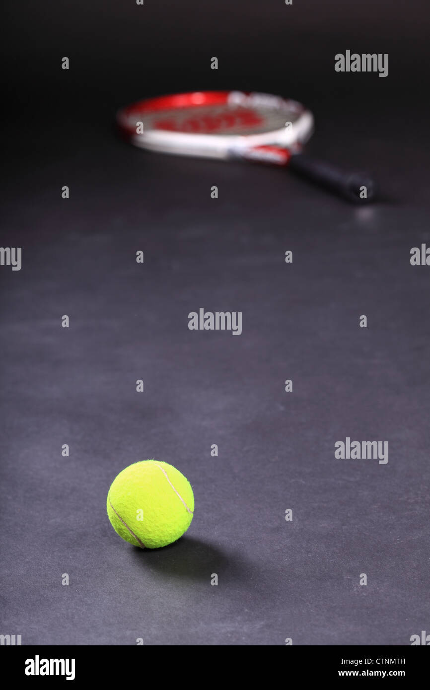 tennis racket and ball on black background studio shot Stock Photo - Alamy
