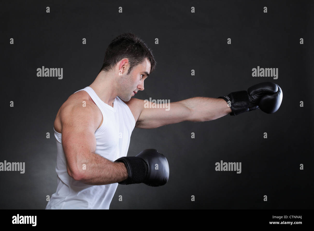 Portrait sportsman boxer in studio against dark background Stock Photo ...