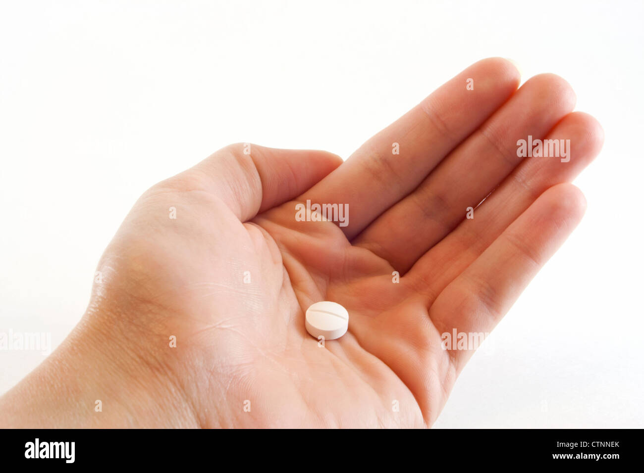 Woman's hand holding one white medicinal tablet in the palm Stock Photo ...