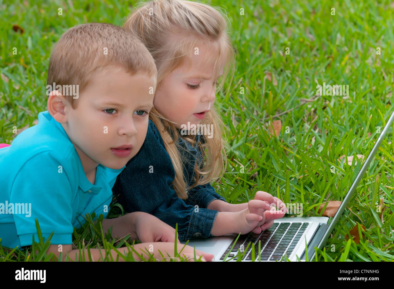 Children learning on a personal computer, mac outdoors Stock Photo - Alamy