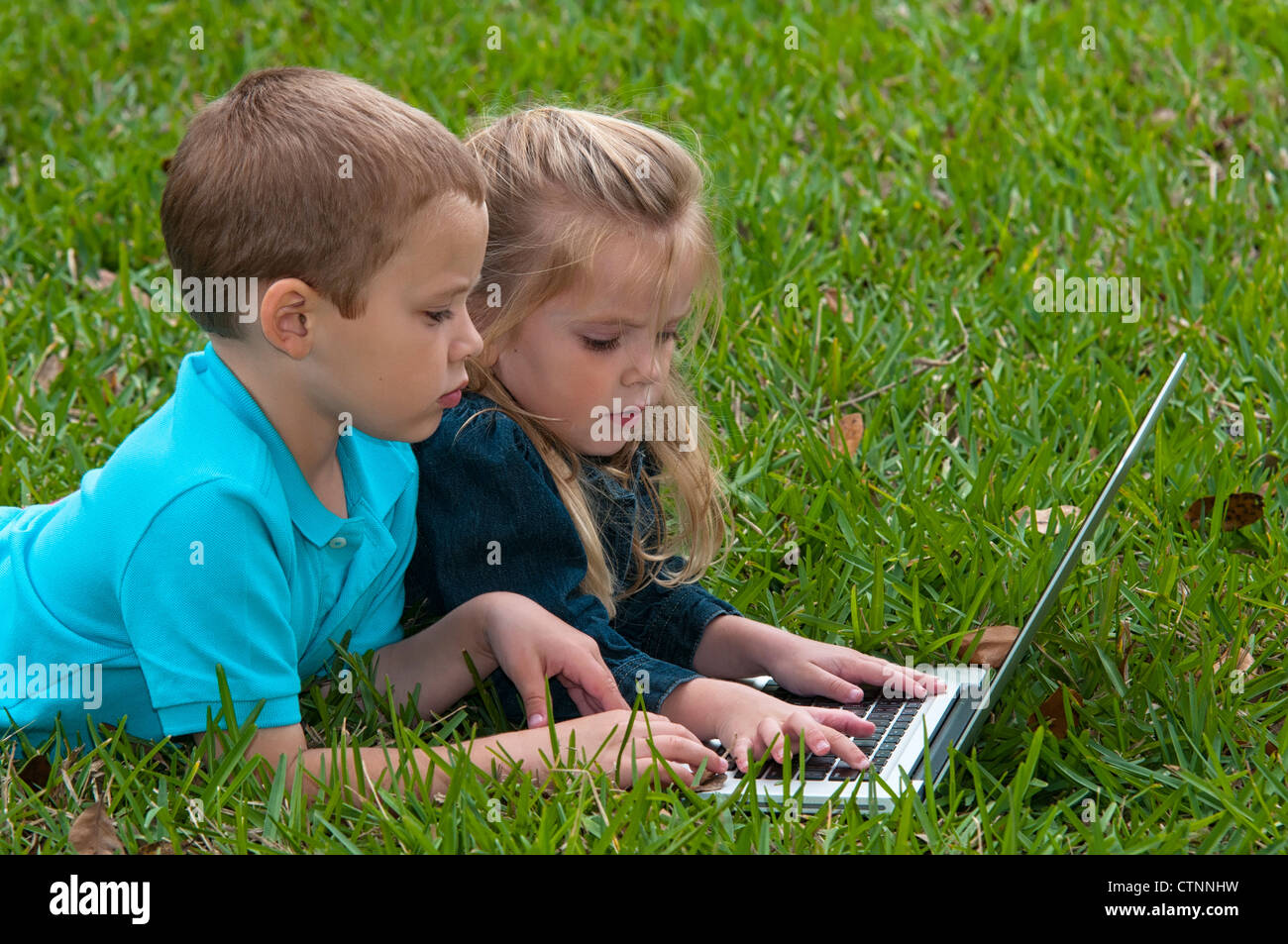 Children learning on a personal computer, mac outdoors Stock Photo - Alamy