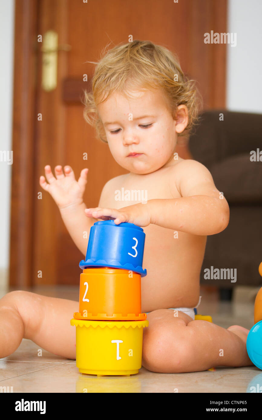 Baby boy playing with his stacking pots Stock Photo - Alamy