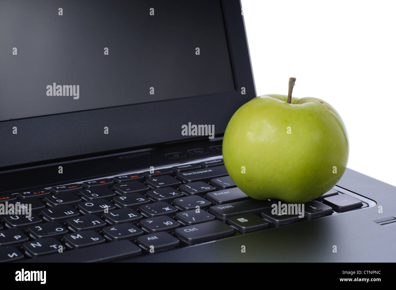 Green apple on laptop keyboard isolated on white background Stock Photo ...