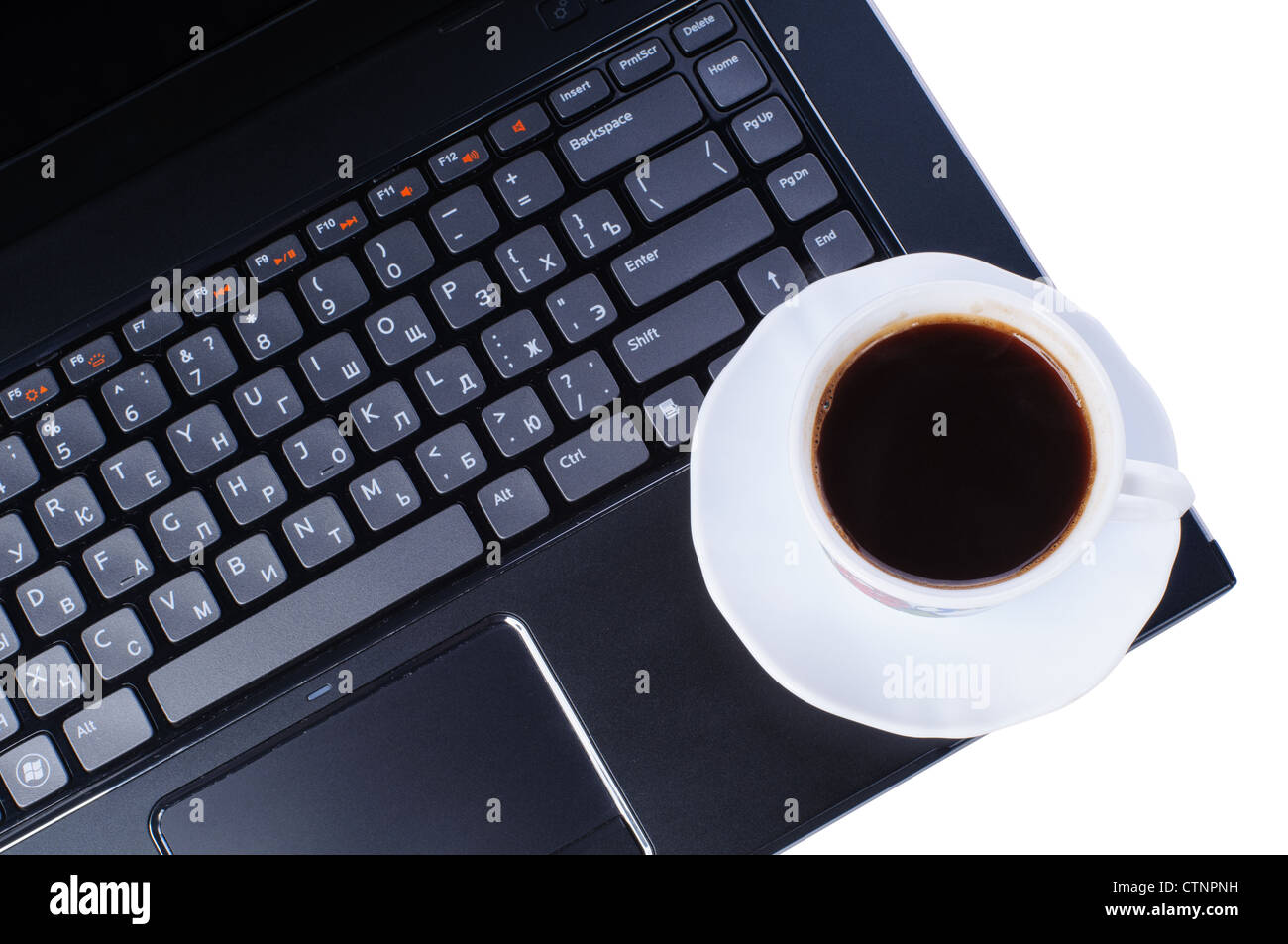 A cup of coffee on laptop keyboard isolated in white background Stock ...