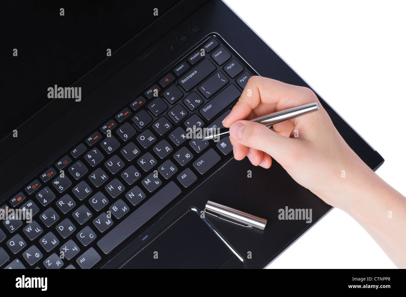 Hand with fountain pen on laptop keyboard isolated on white background ...