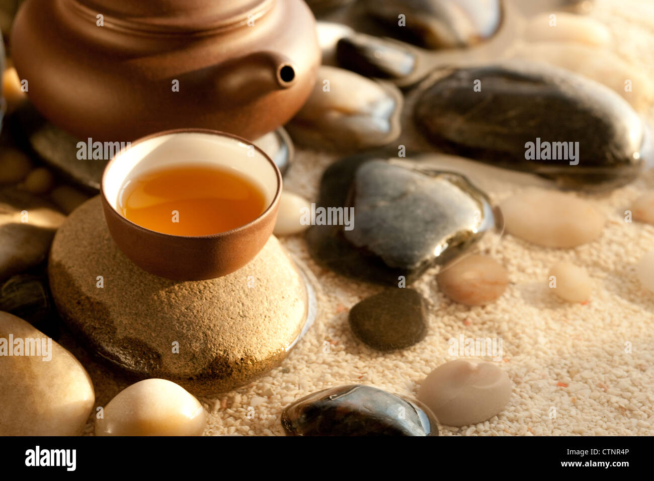 Tea set and pebbles Stock Photo - Alamy