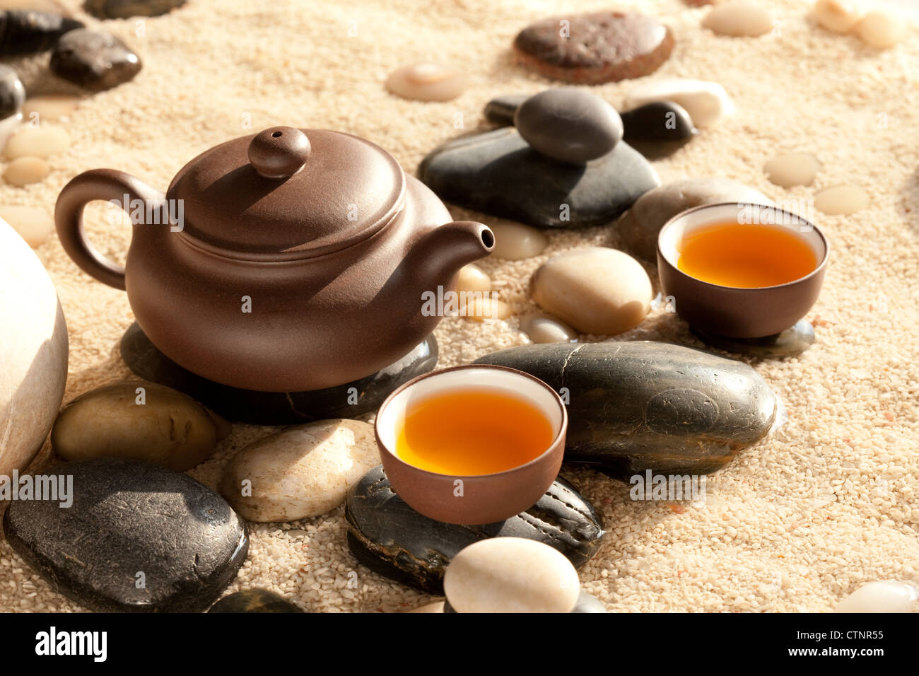 Tea set and pebbles Stock Photo - Alamy