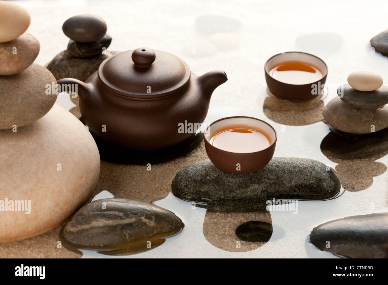 Tea set and pebbles Stock Photo - Alamy